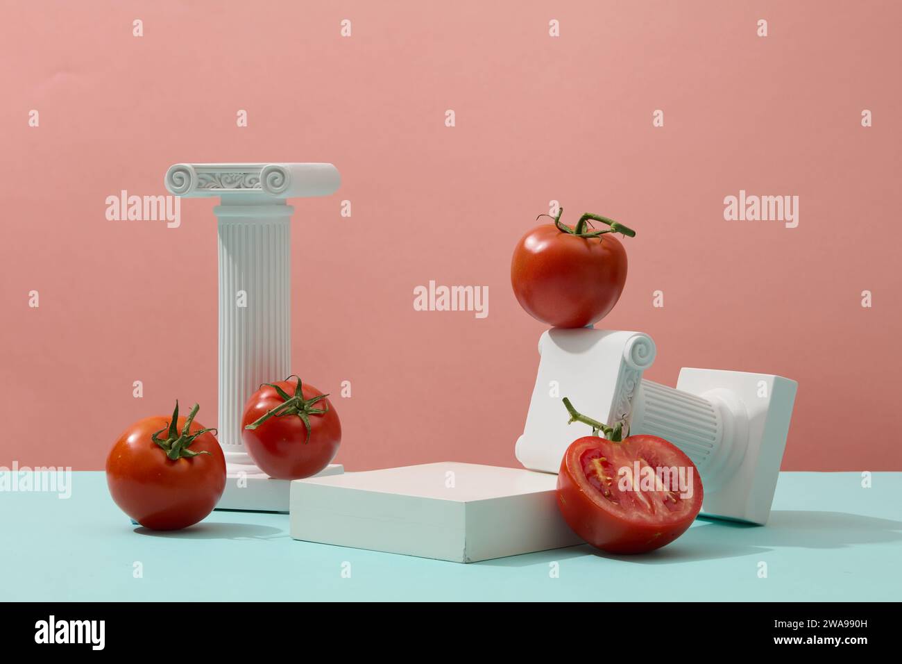 Some red tomatoes displayed around a podium in white color. Product ...