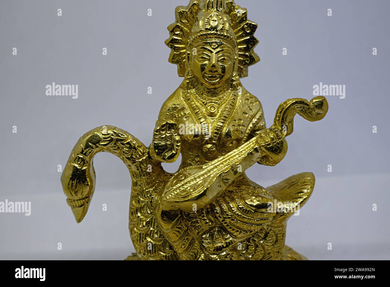 Idol of Goddess Devi Saraswati made of brass, isolated on a white ...