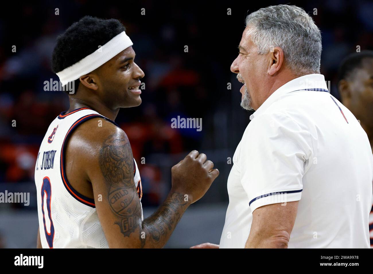 Auburn guard K.D. Johnson (0) talks with coach Bruce Pearl during the ...