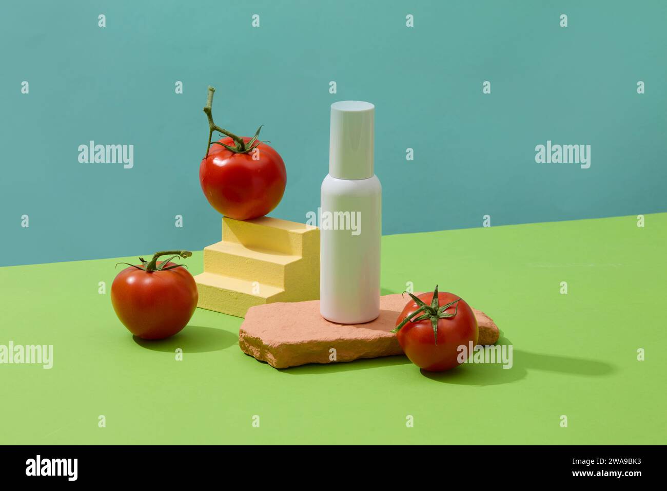 Cosmetic bottle in white color decorated with few tomatoes. Skin care ...