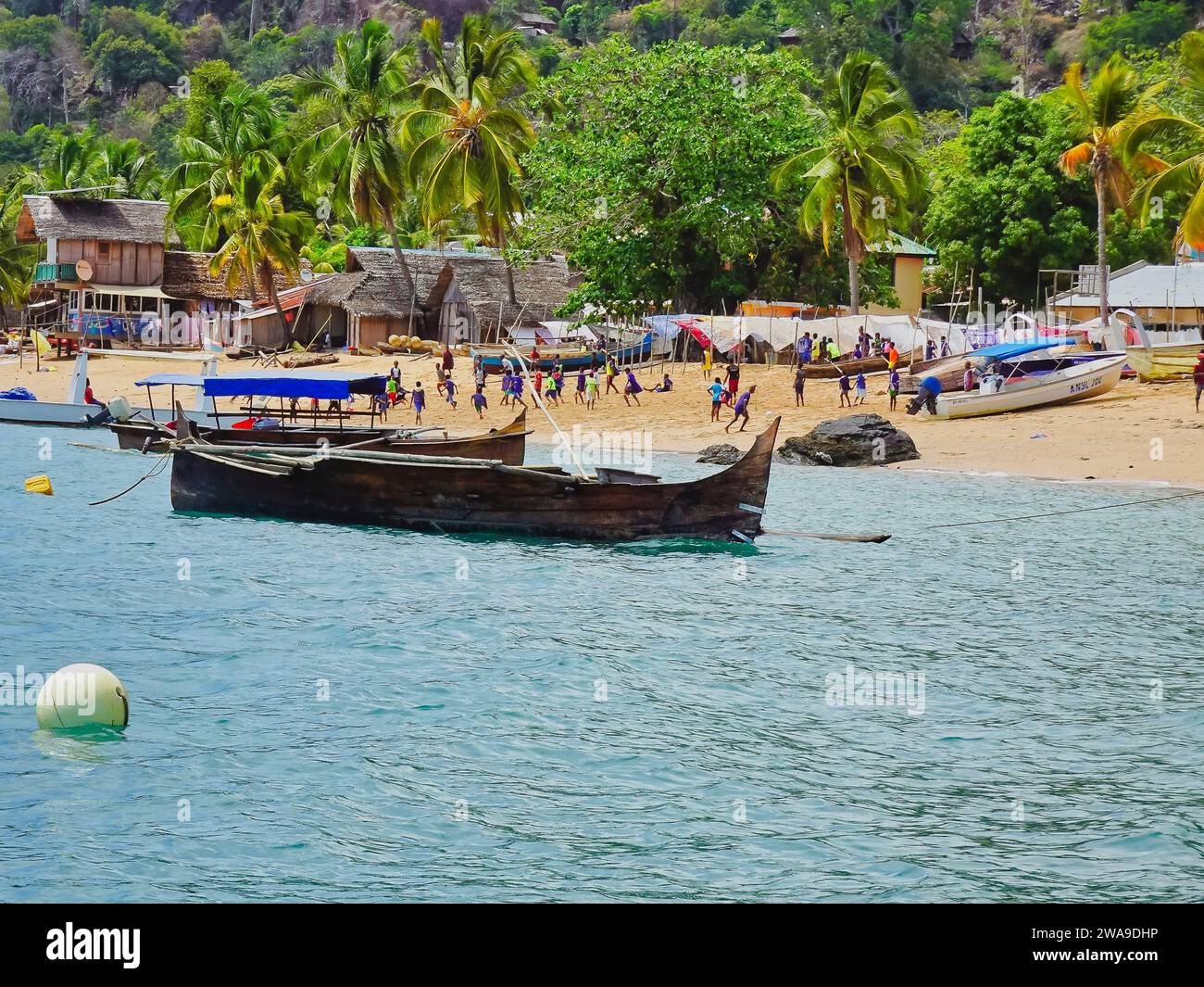Locals active on the beach in Ampangorina on Nosy Komba Island ... Locals active on the beach in Ampangorina on Nosy Komba Island ...