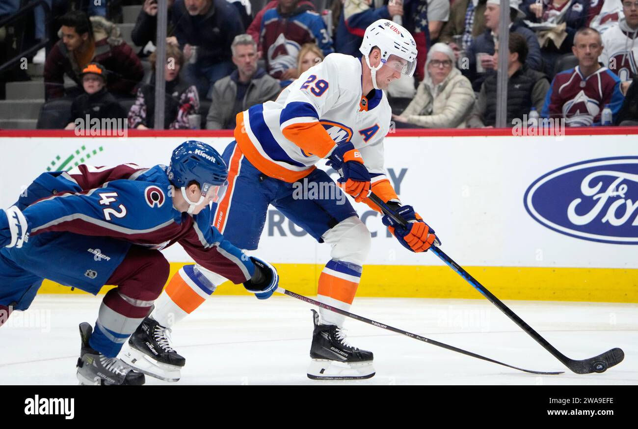 New York Islanders center Brock Nelson, right, passes the puck as ...