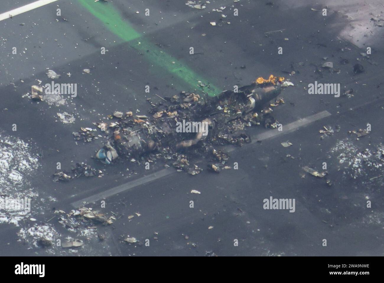 An aerial photo shows a Japan Coast Guard (JCG) aircraft burnt after a ...