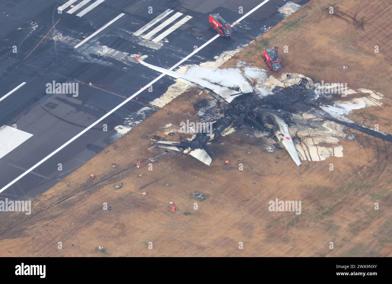 An aerial photo shows Japan Airlines flight 516 burnt on the runway at ...