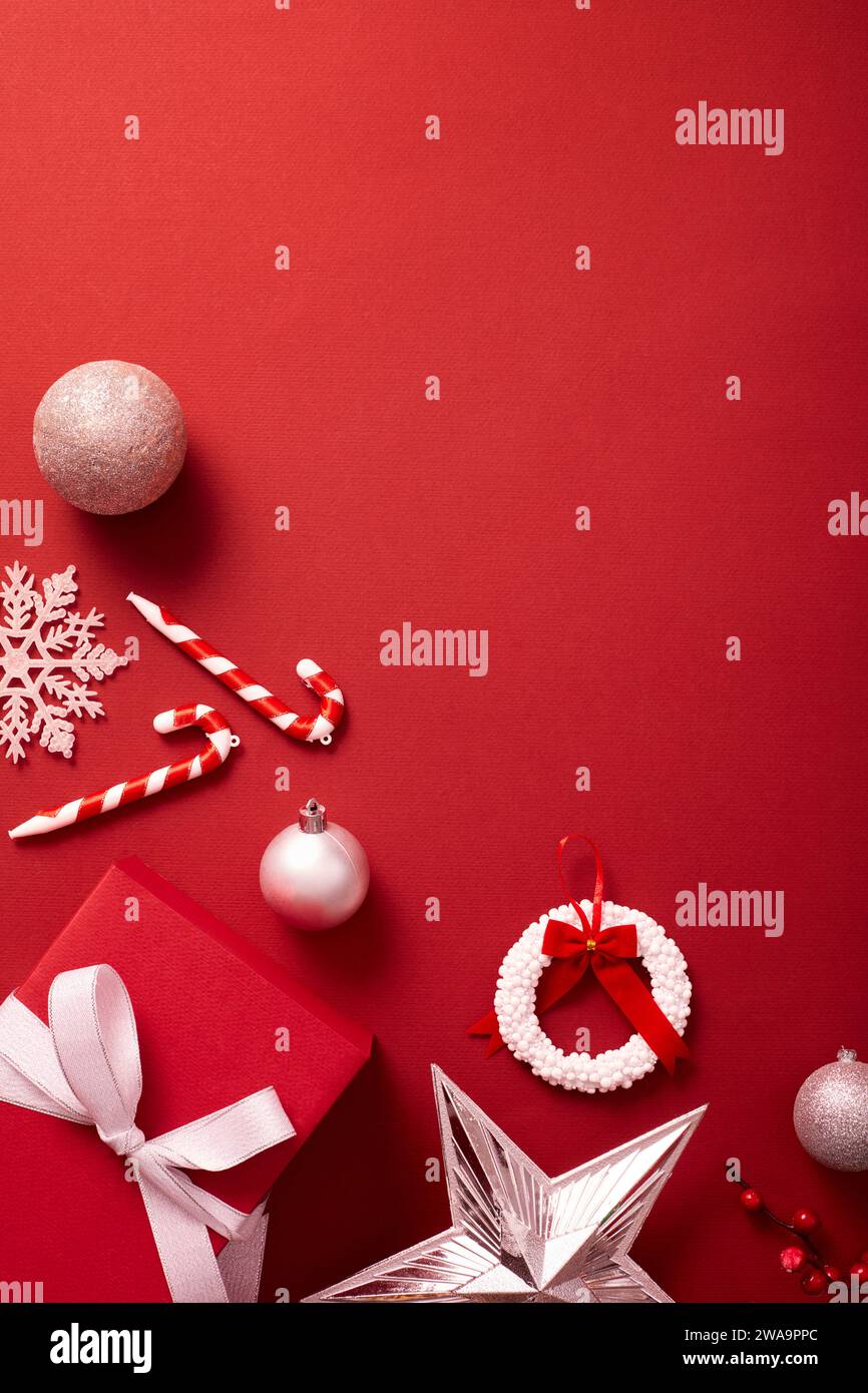 Top view of many Christmas decorations placed on the red background ...