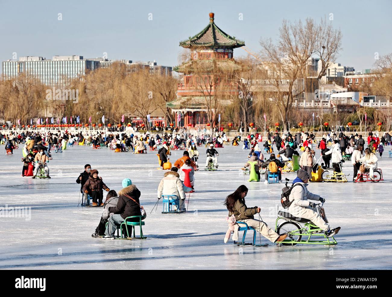 Tourists enjoy ice and snow fun at Shichahai ice rink in Beijing, China ...