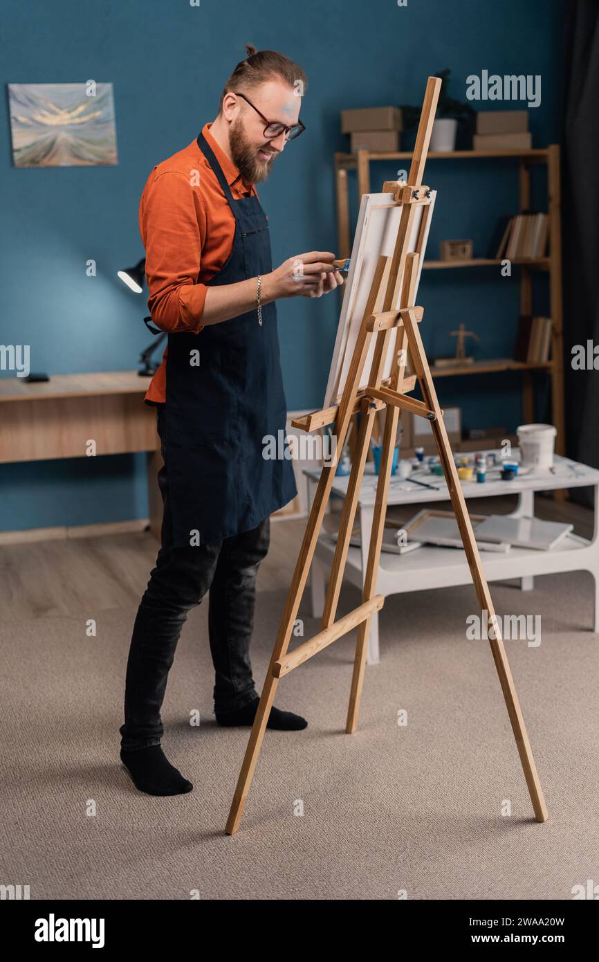 Happy artist drawing art work working in his studio Stock Photo - Alamy