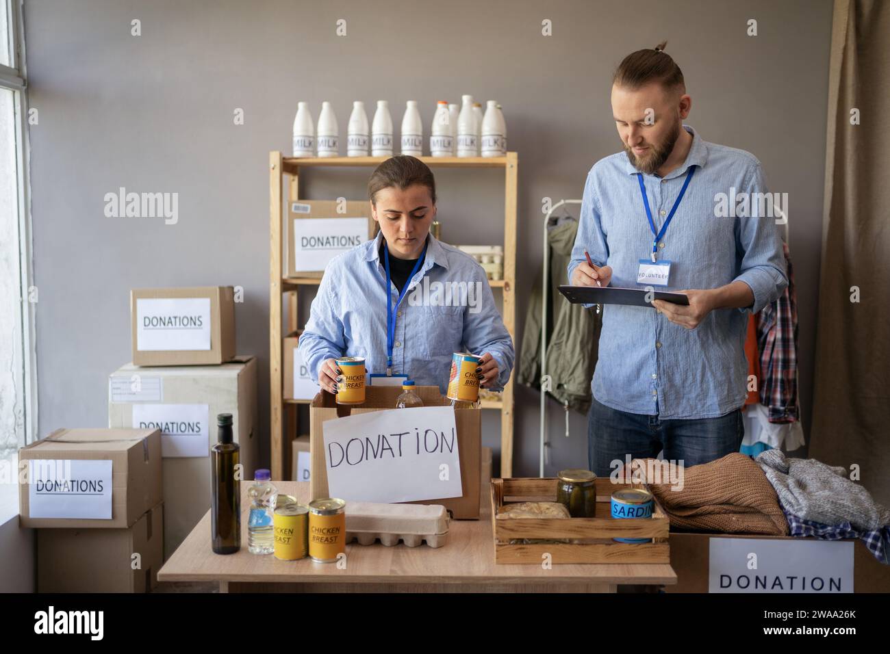 Two people working in charitable foundation. Happy volunteer at ...