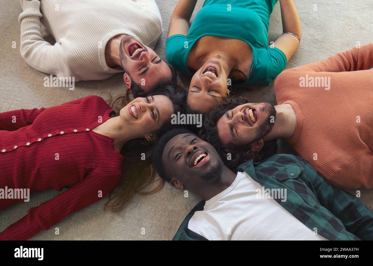 Happy Group of friends lying and making a circle, afro and caucasian ...