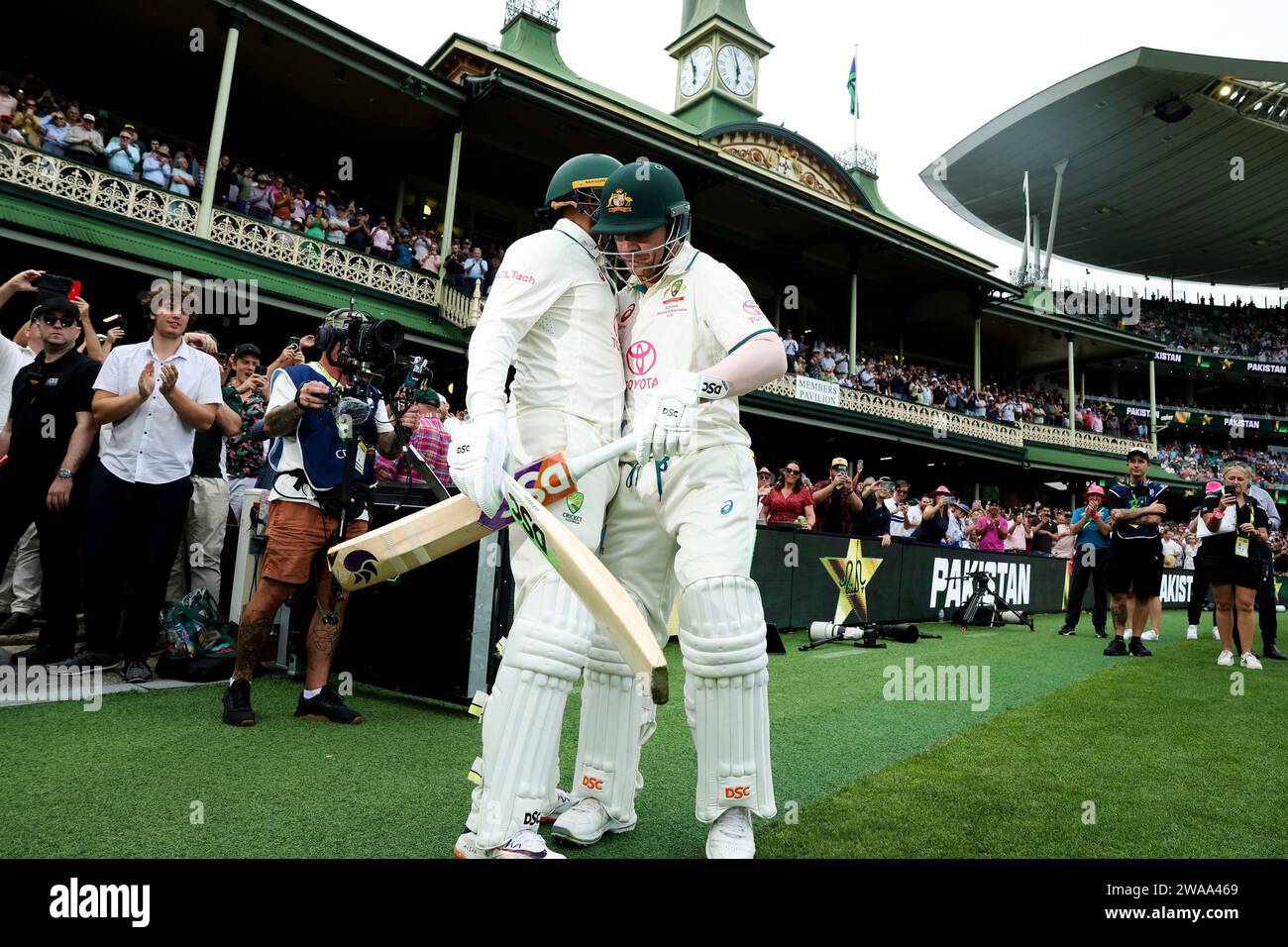 SYDNEY, AUSTRALIA - JANUARY 03: David Warner of Australia embraces Usman Khawaja of Australia ...