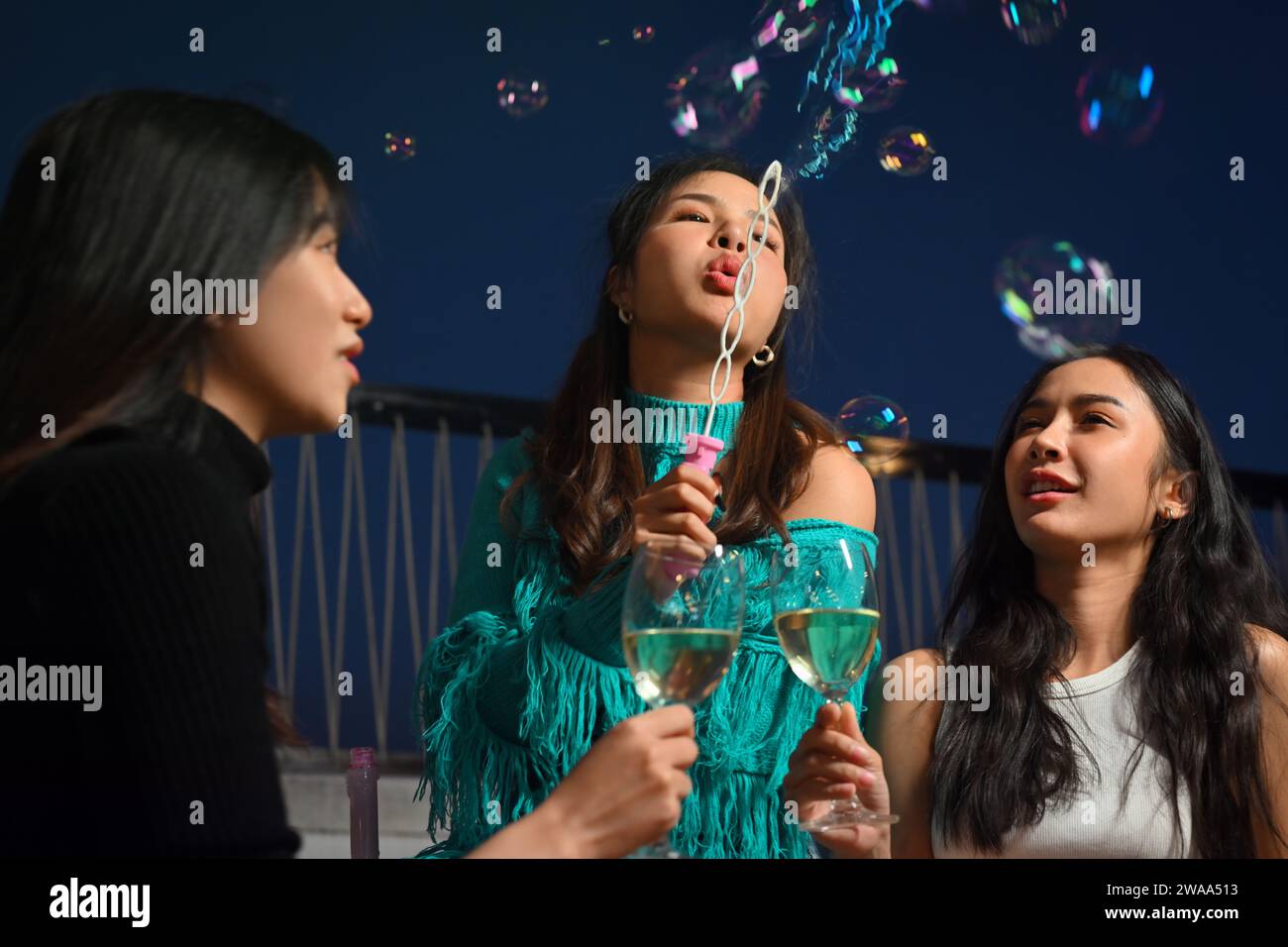 Happy friends having fun enjoy chill with drinks and blowing soap ...