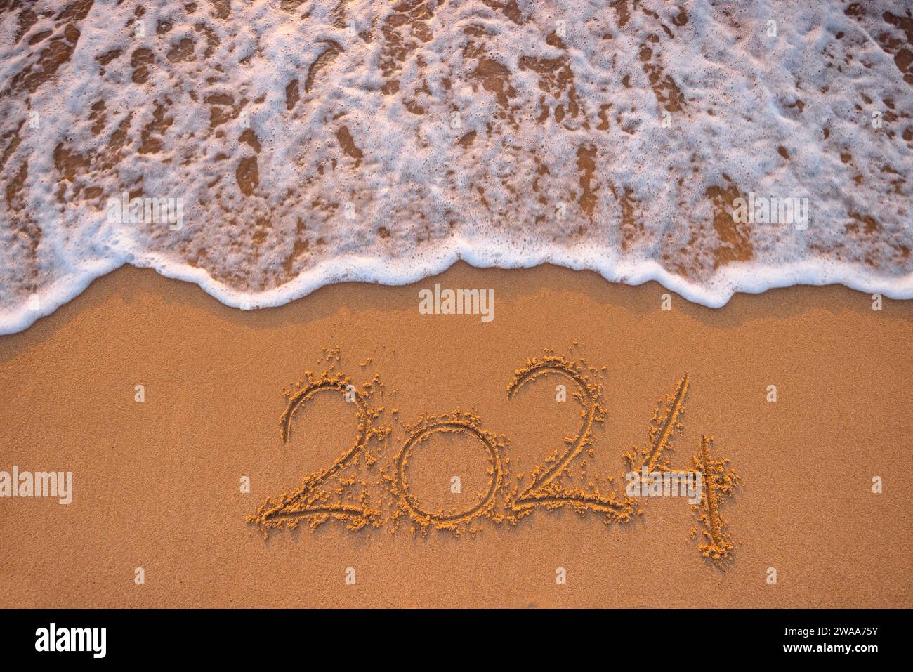 Happy New Year 2024 concept, lettering on the beach. Written text on ...