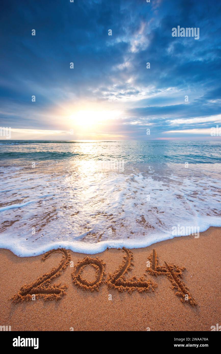 Sea sunrise over tropical island beach and handwritten text in sand new ...