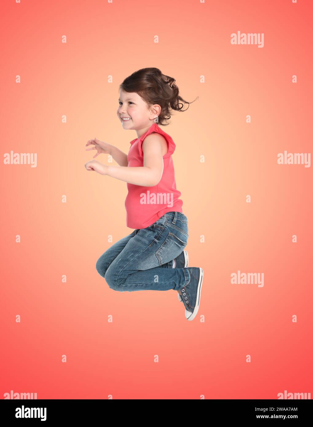 Happy cute girl jumping on color gradient background Stock Photo - Alamy