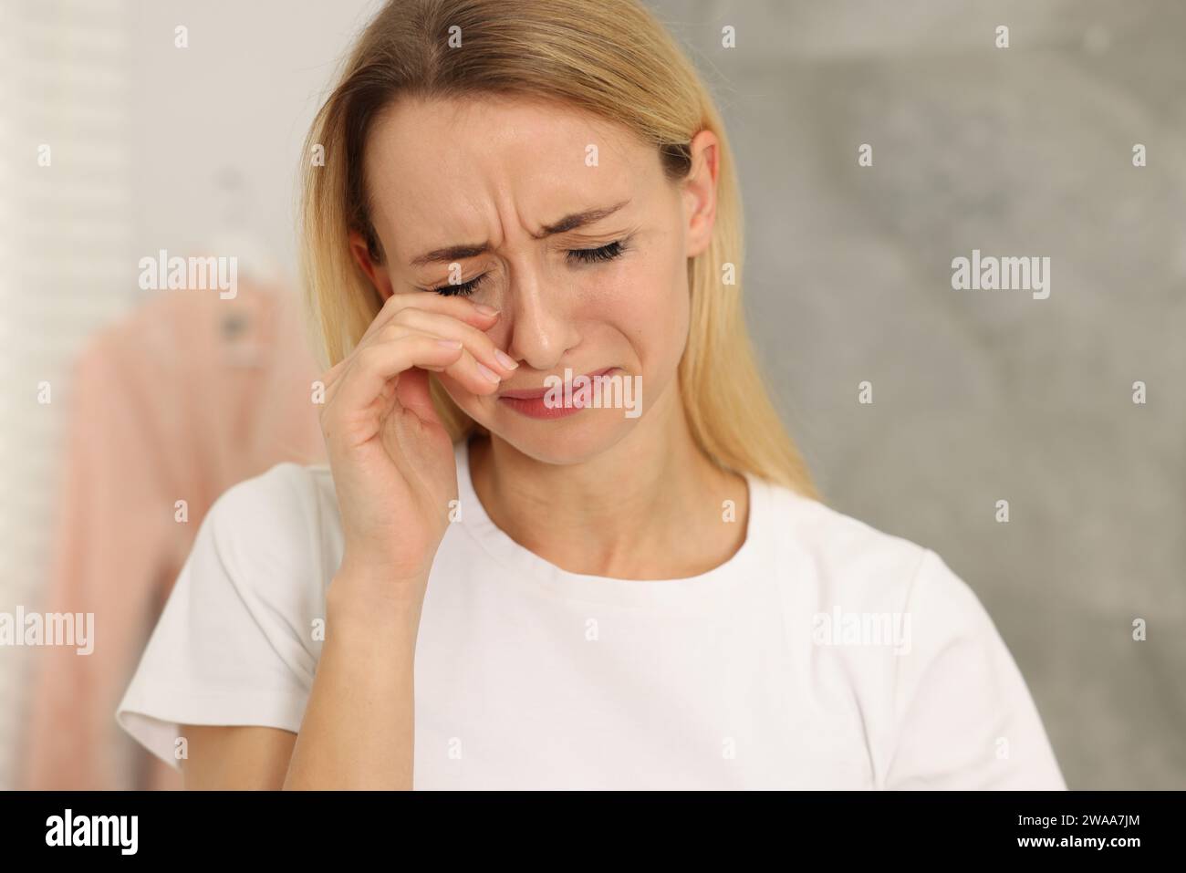 Sad woman with smeared mascara crying indoors Stock Photo - Alamy