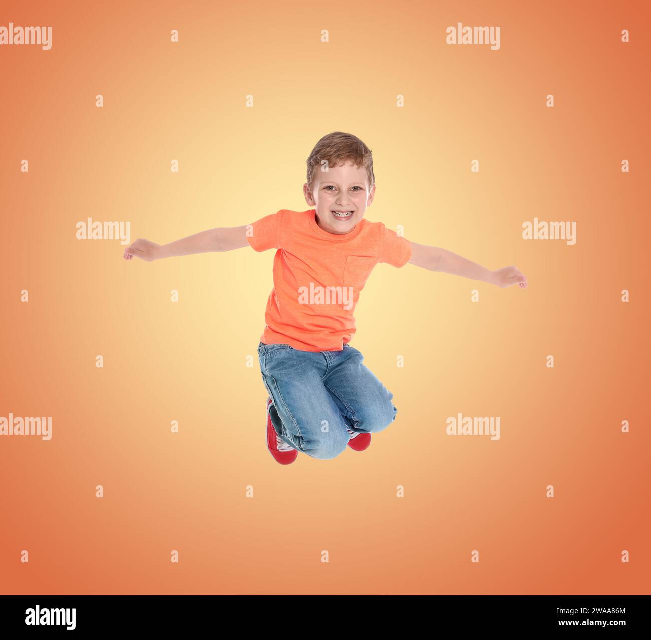 Happy boy jumping on color gradient background Stock Photo - Alamy