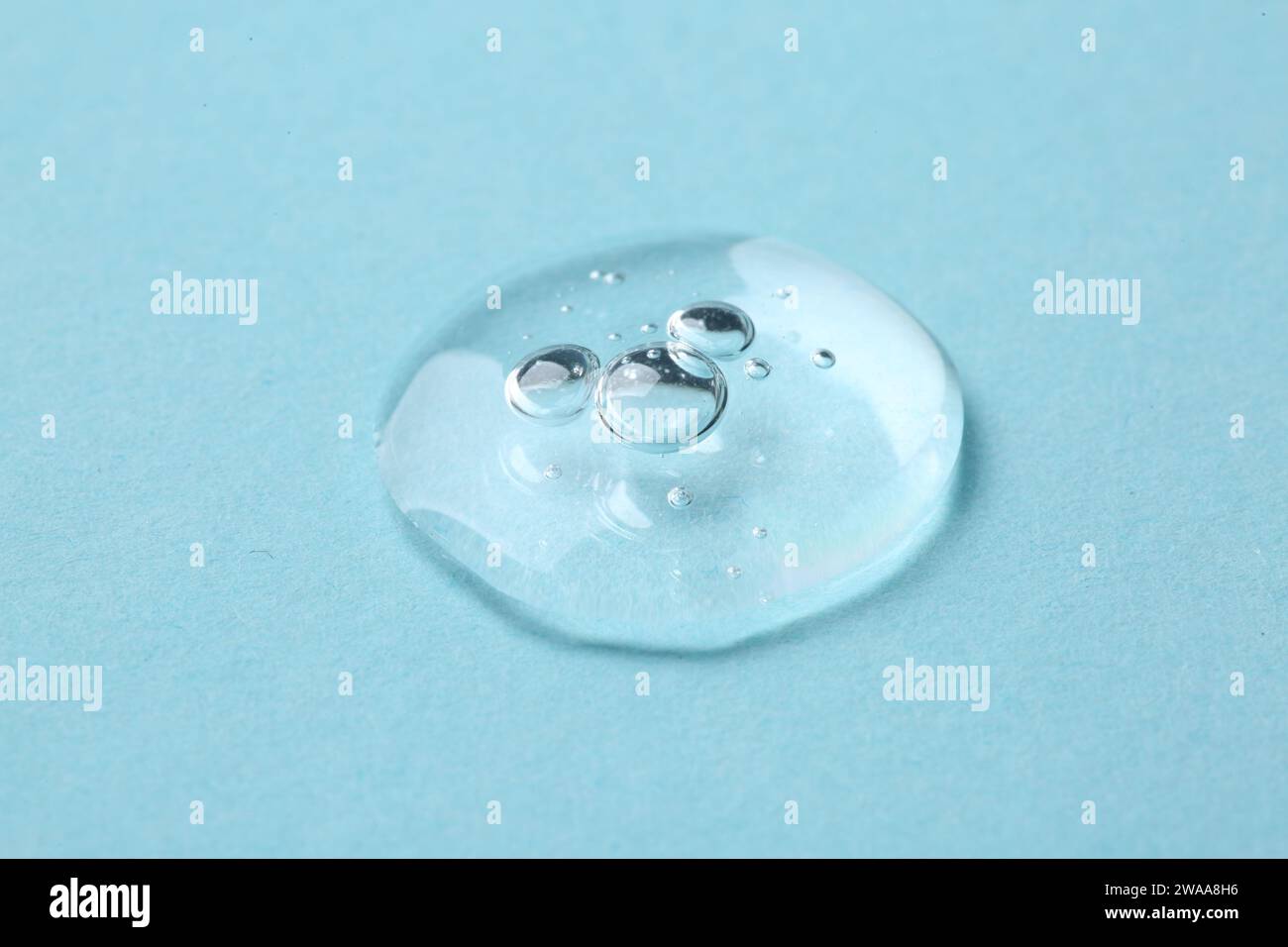Drop of cosmetic serum on light blue background, closeup Stock Photo ...