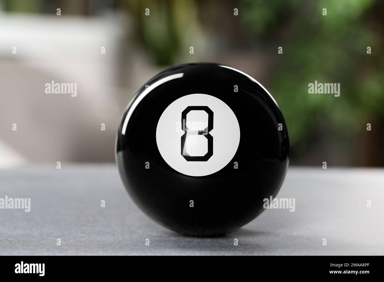 Magic eight ball on light gray table, closeup Stock Photo - Alamy
