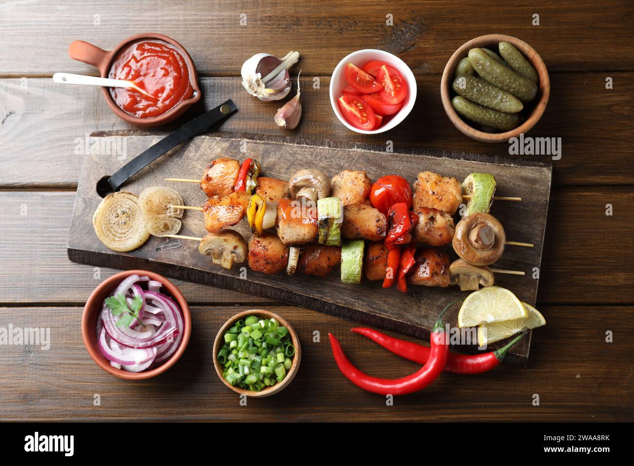 Delicious shish kebabs, mushroom, tomato and zucchini served on wooden ...