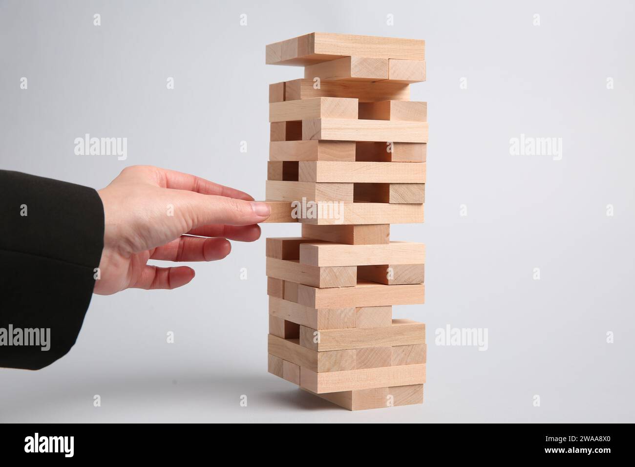 Woman playing Jenga on light gray background, closeup Stock Photo - Alamy