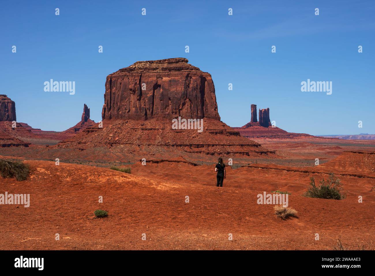 A women dressed in black admiring the rock formation in Monument valley ...