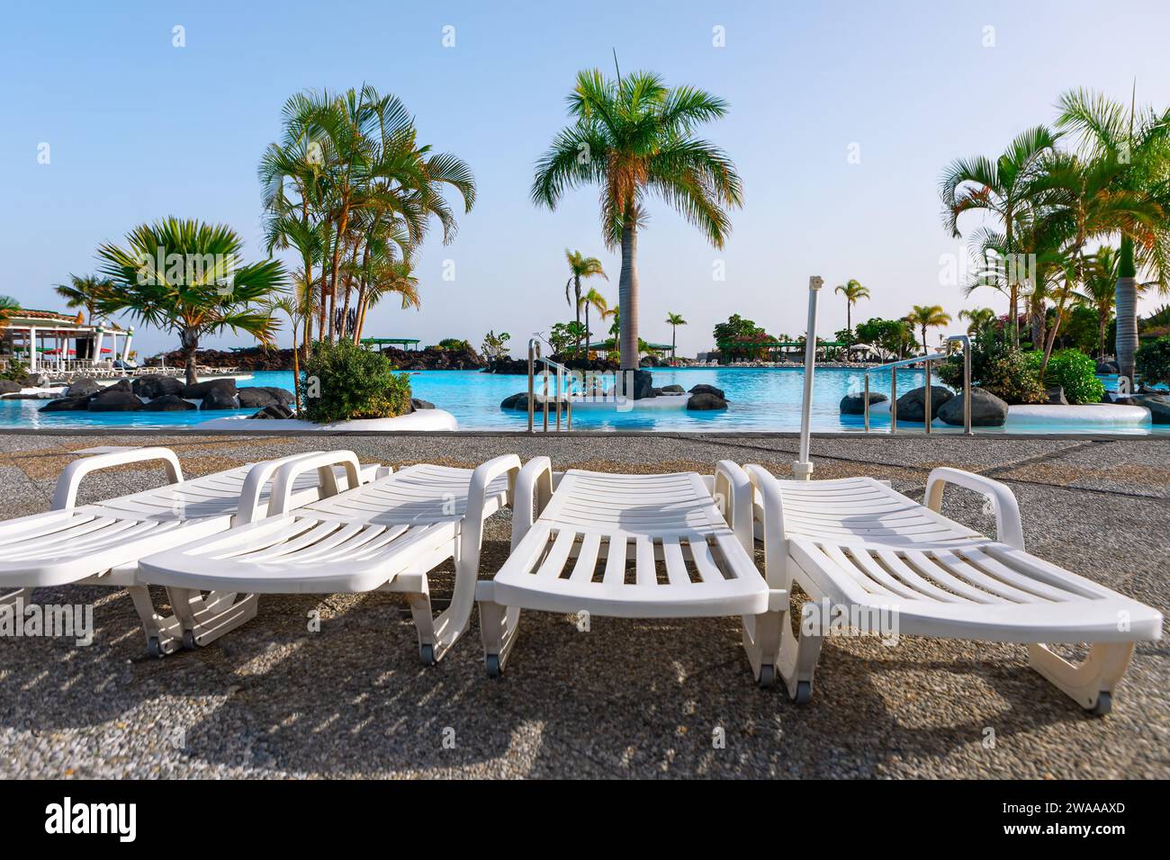 Sun loungers by the swimming pool in luxury hotel resort Stock Photo ...