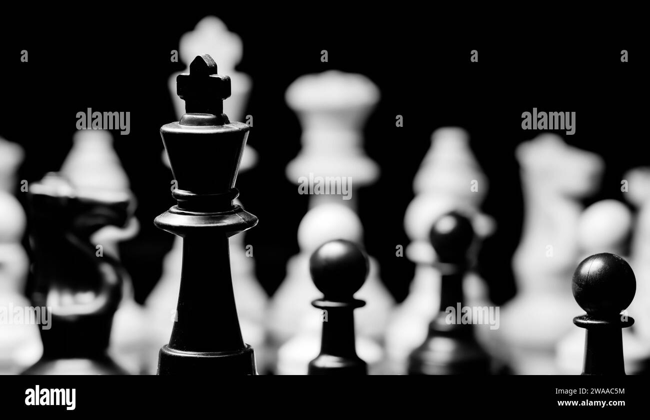 Close up of Chess pieces on a reflective mirror board surface with a ...