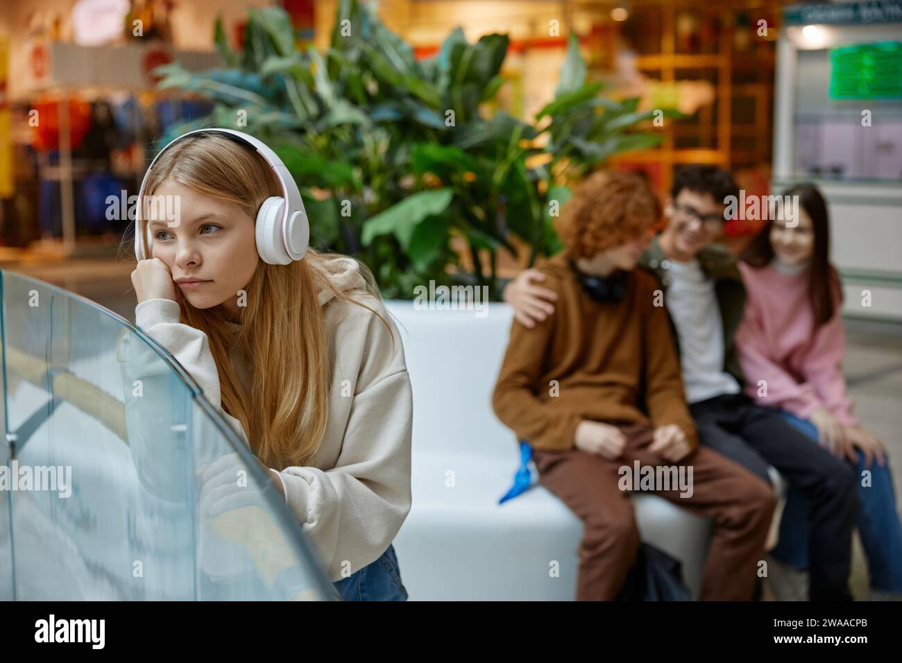 Little girl feeling upset to be ignoring with older friends, in ...