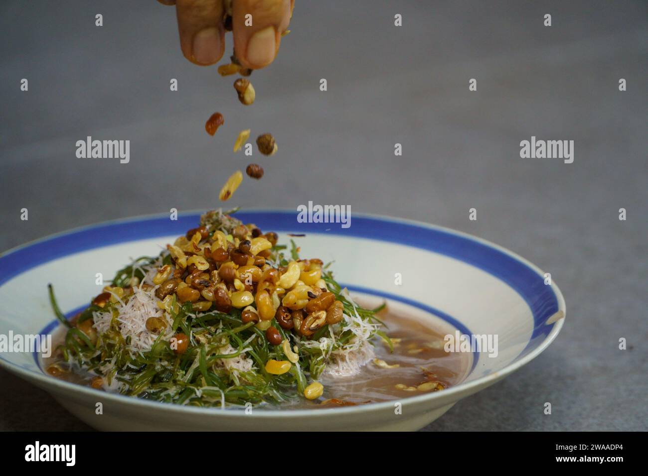 A Close up photo of the fresh seaweed on a plate. In Bali, its called ...