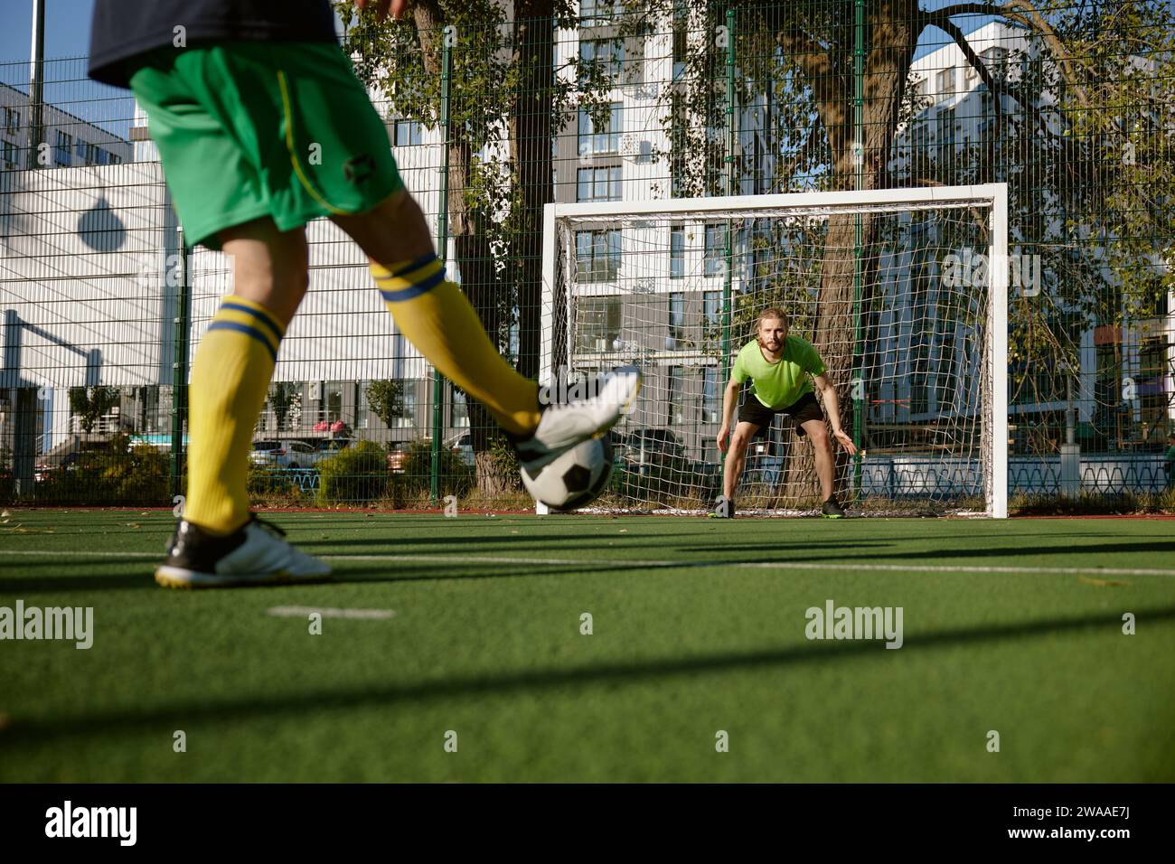 Football player aiming soccer ball trying to score goal Stock Photo - Alamy