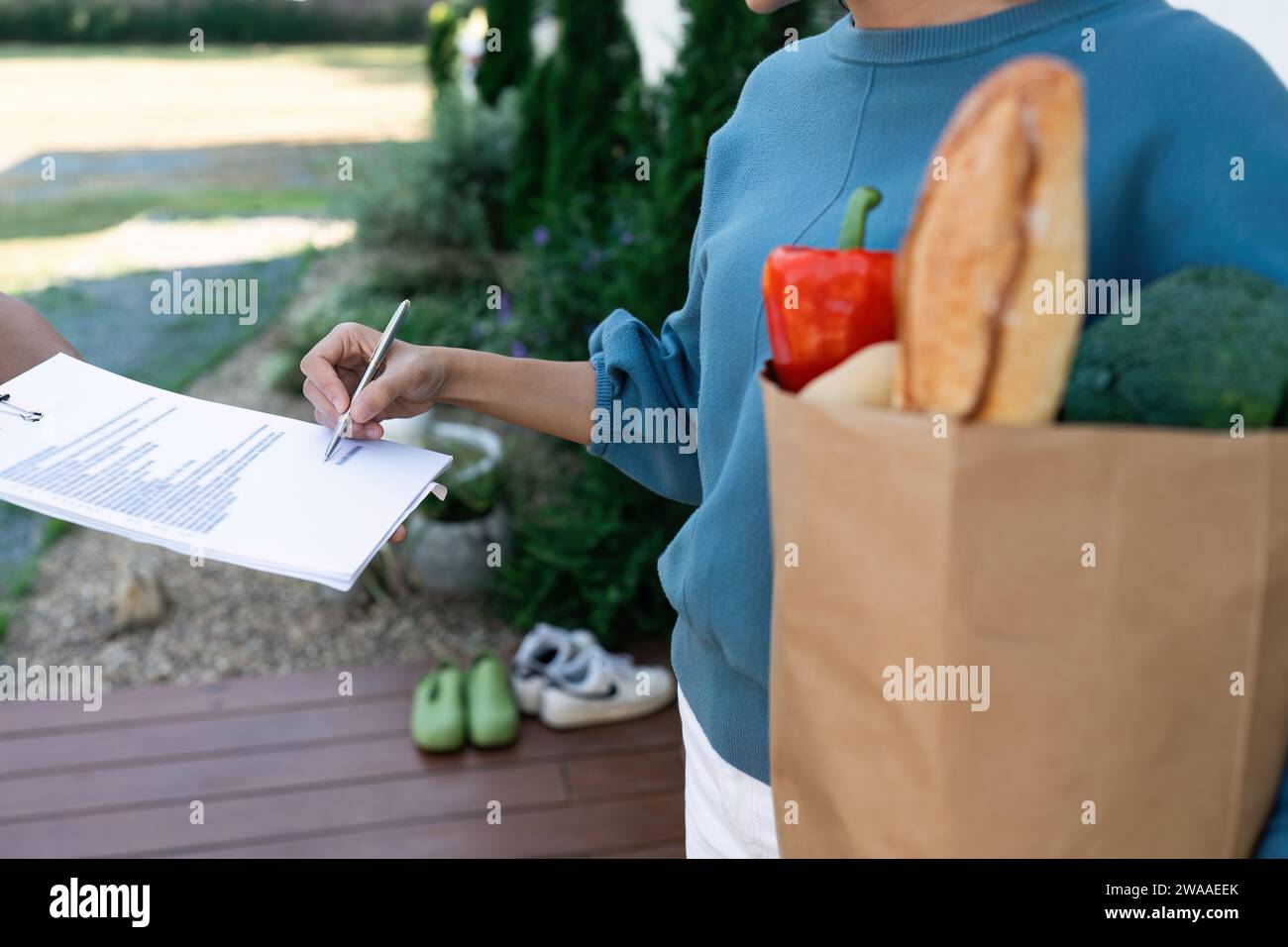 Woman customer signing receipt hi-res stock photography and images - Alamy