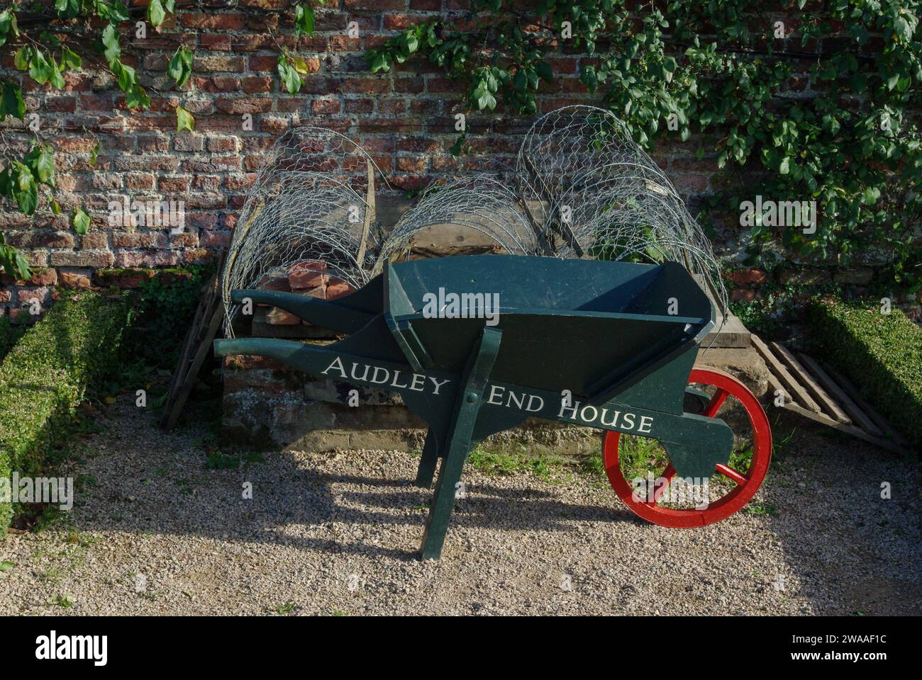 Red and green painted wooden wheelbarrow, marked Audley End Gardens ...