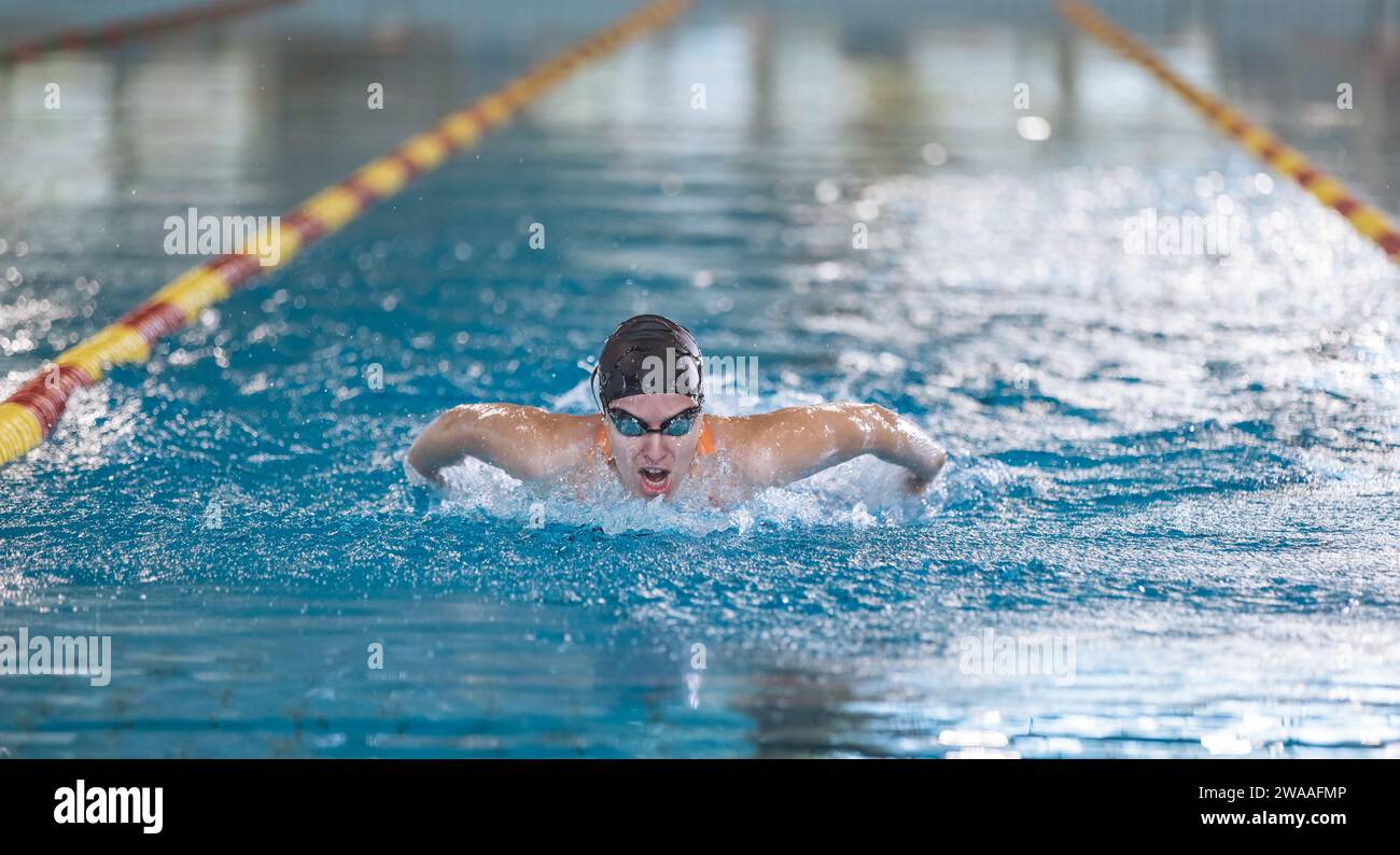 Female competitive swimmer moving through the water performing the ...