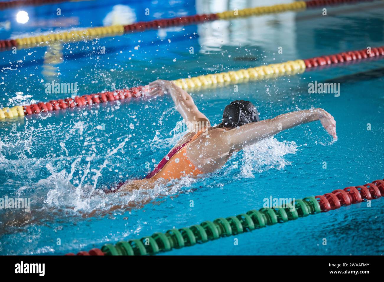 Female competitive swimmer moving through the water performing the ...