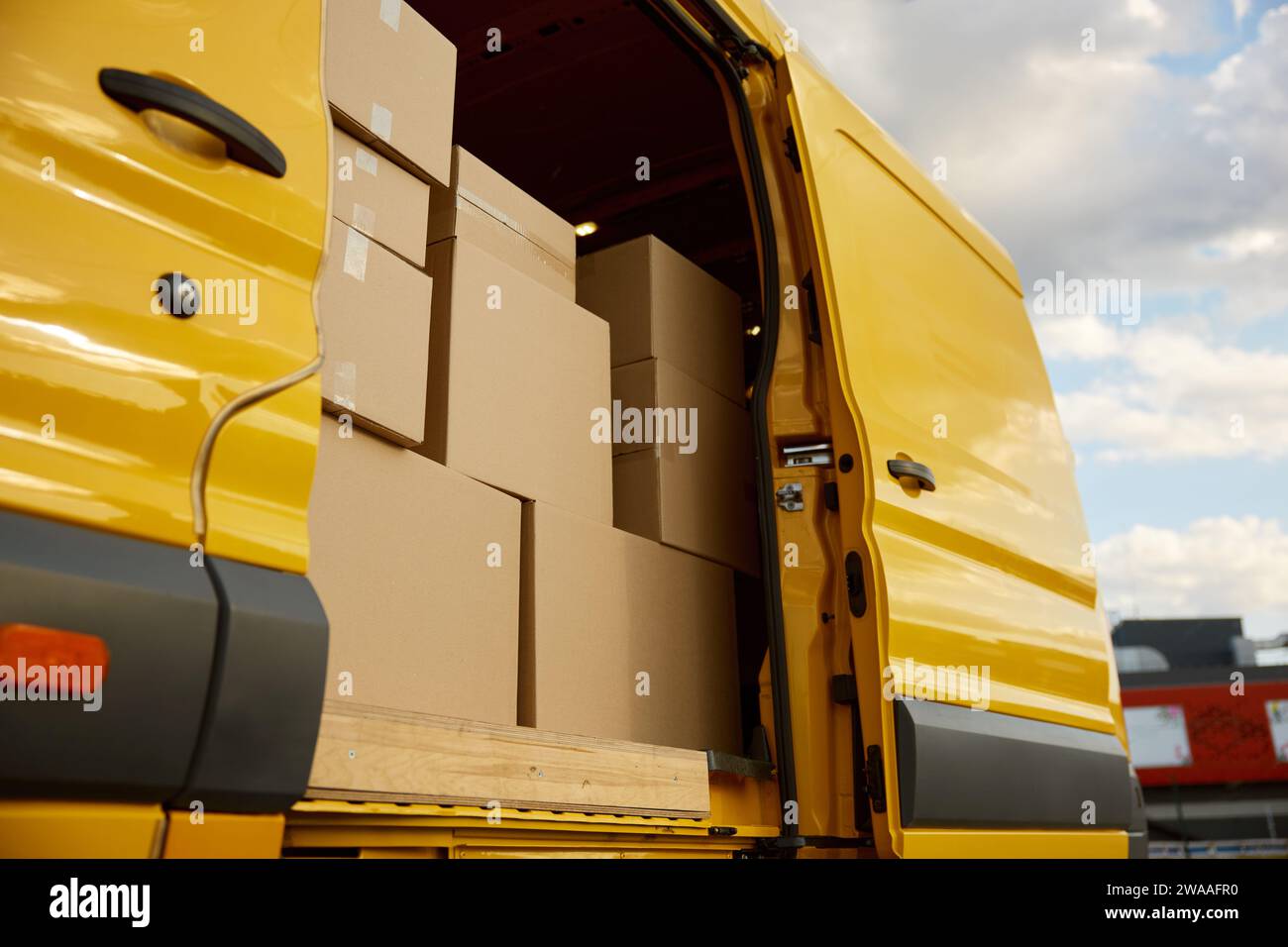 Closeup opened mini van doors and cardboard parcel boxes inside Stock ...