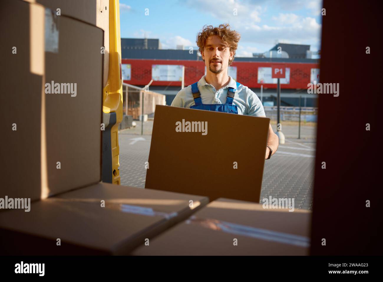 Warehouse worker loading van preparing parcel box for delivery Stock ...