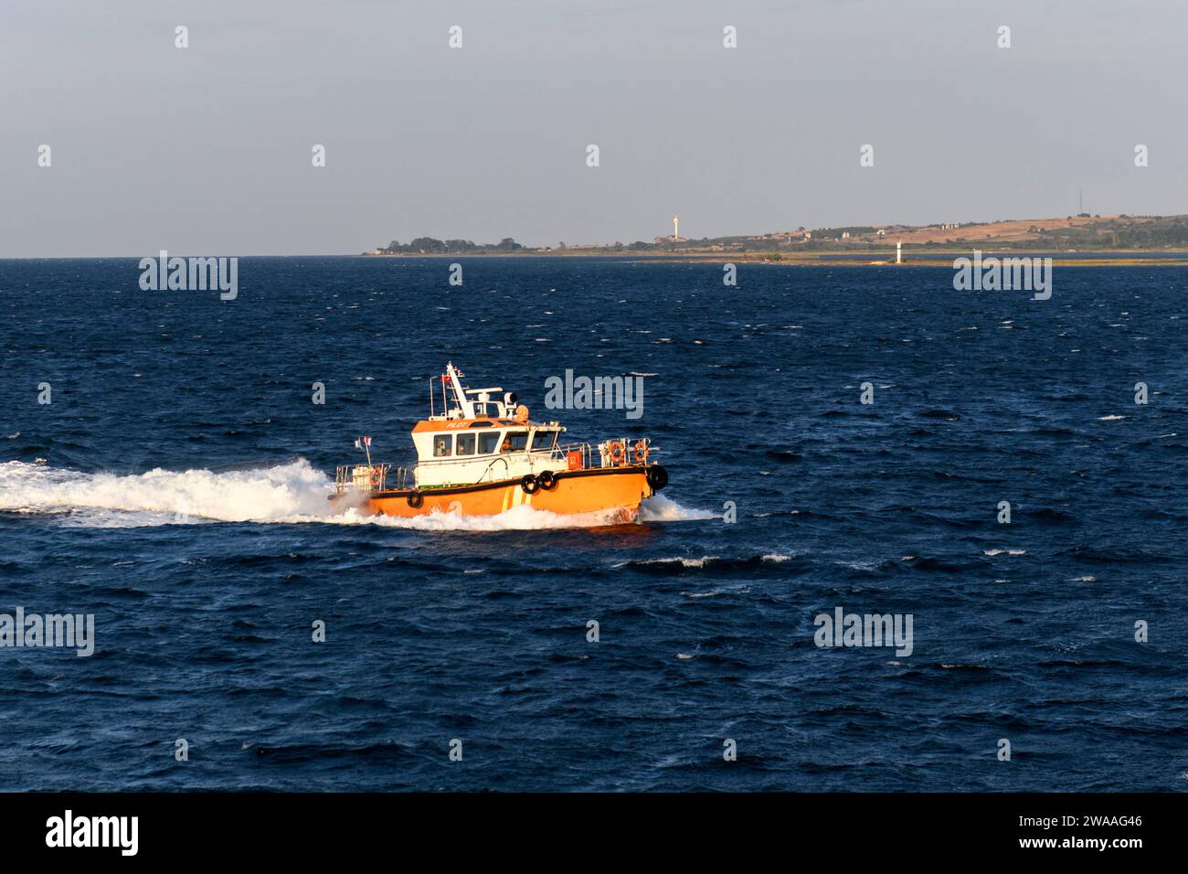 Pilot boat and cargo vessel at sea. Pilot embarkation. Pilotage Stock ...