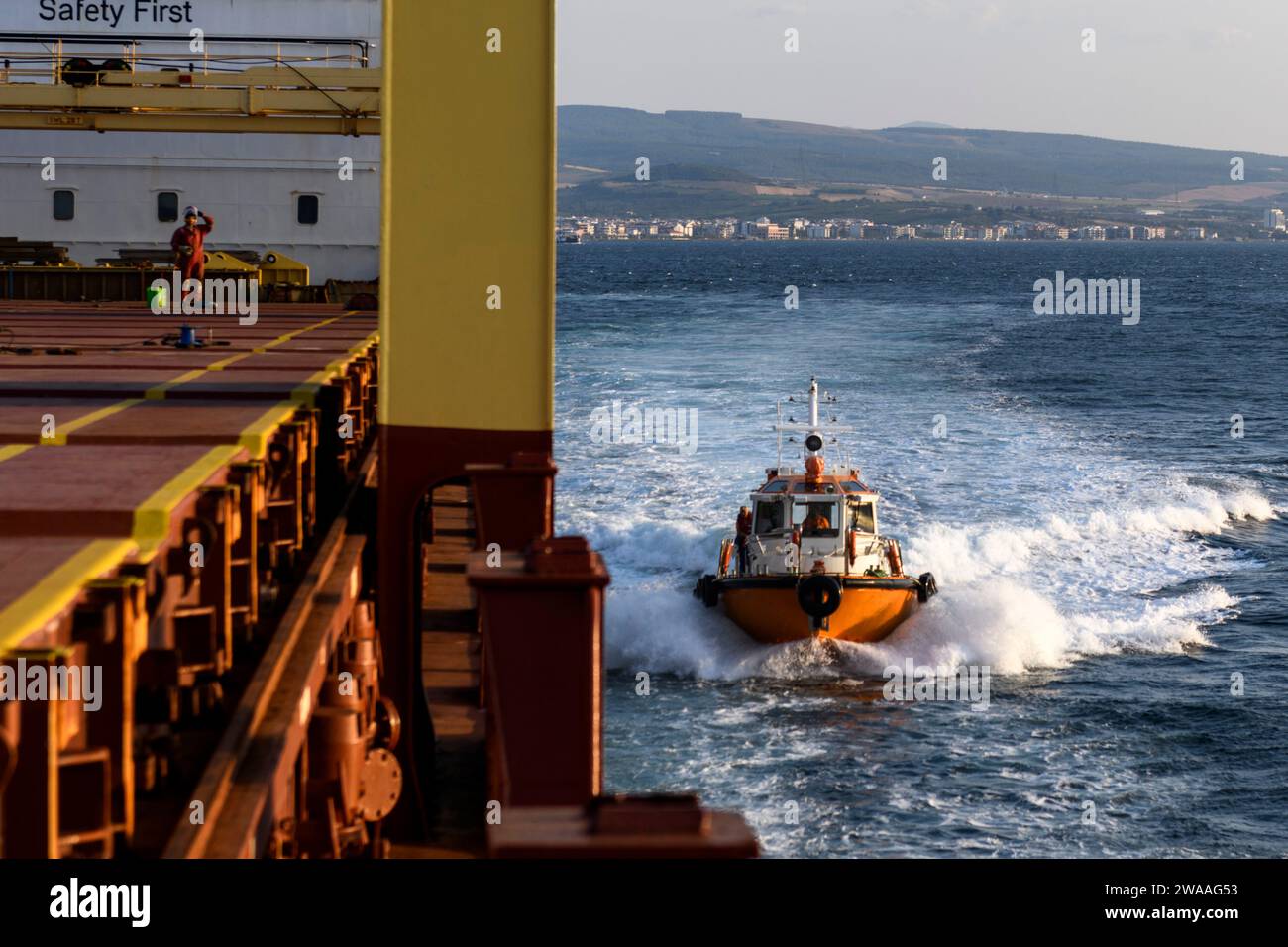 Pilot boat and cargo vessel at sea. Pilot embarkation. Pilotage Stock ...