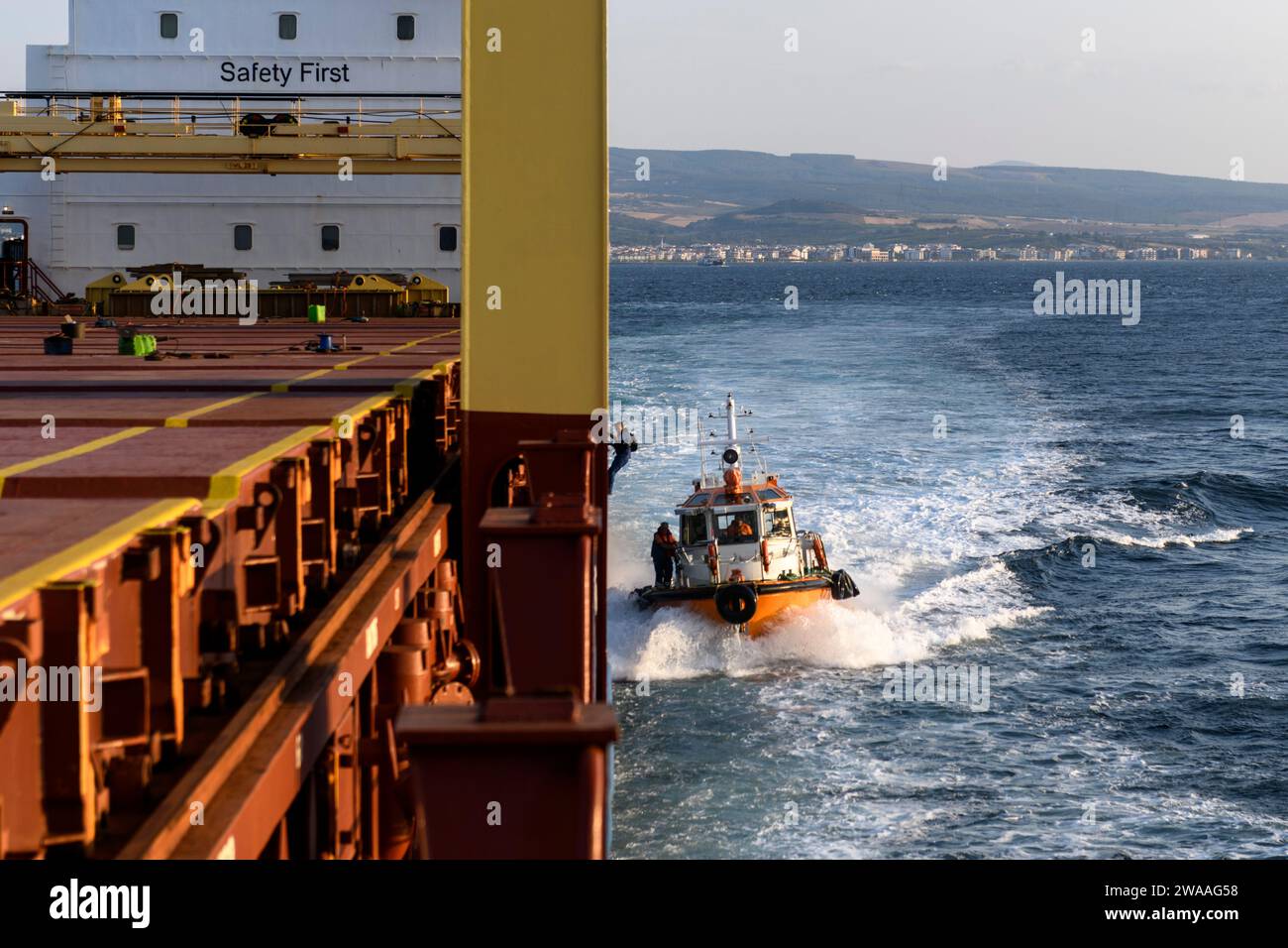 Pilot boat and cargo vessel at sea. Pilot embarkation. Pilotage Stock ...