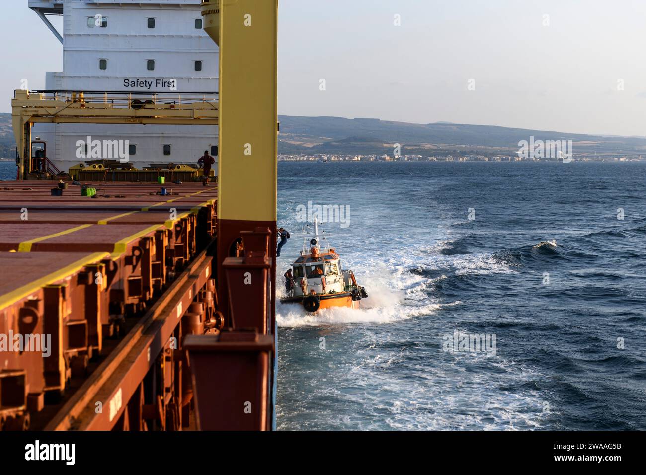 Pilot boat and cargo vessel at sea. Pilot embarkation. Pilotage Stock ...
