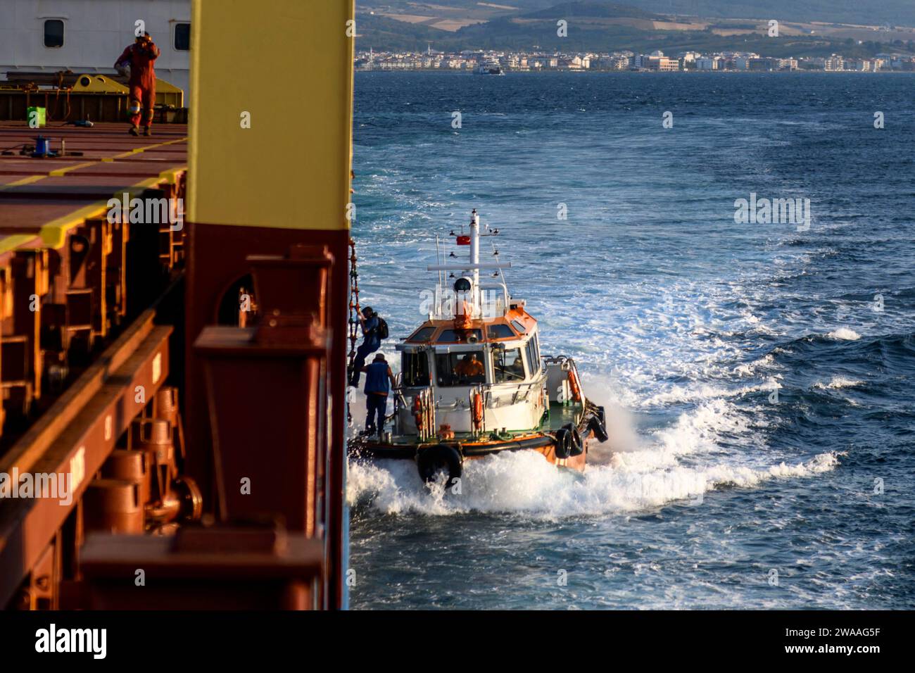Pilot boat and cargo vessel at sea. Pilot embarkation. Pilotage Stock ...