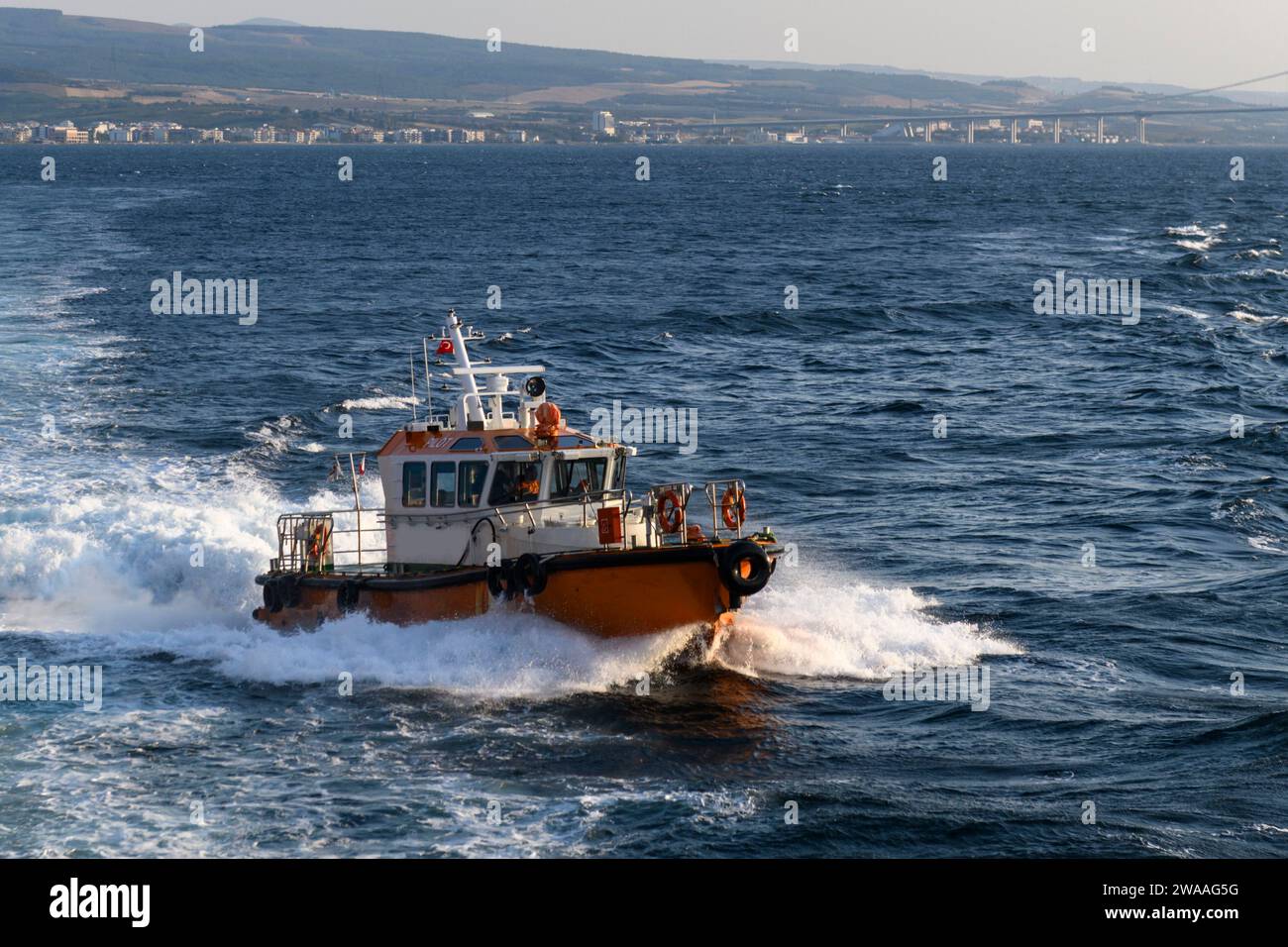 Pilot boat and cargo vessel at sea. Pilot embarkation. Pilotage Stock ...