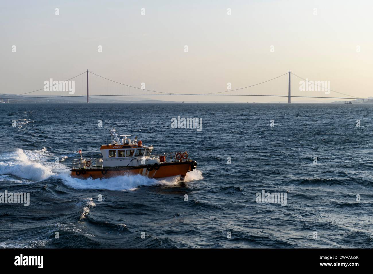 Pilot boat and cargo vessel at sea. Pilot embarkation. Pilotage Stock ...
