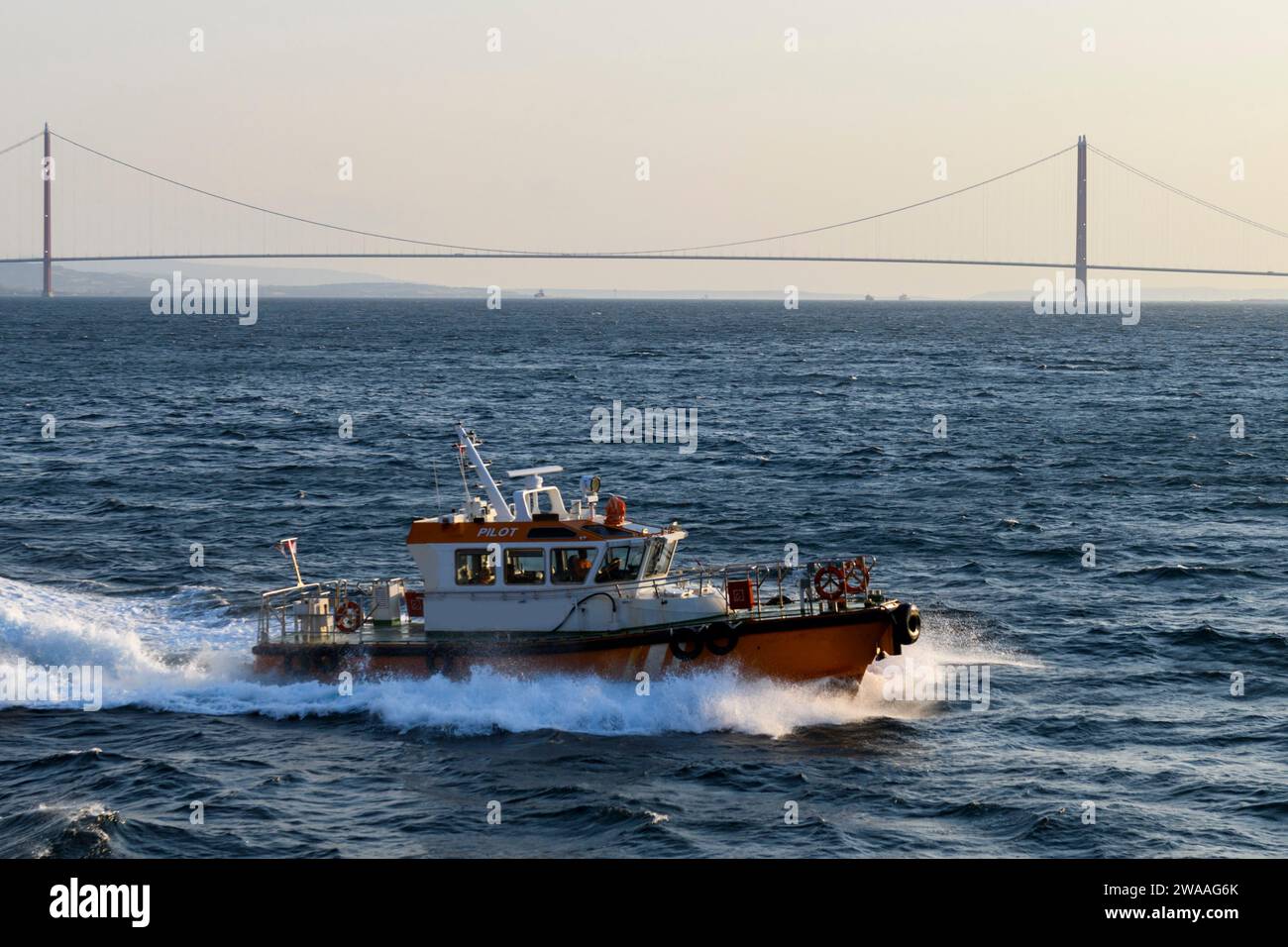 Pilot boat and cargo vessel at sea. Pilot embarkation. Pilotage Stock ...