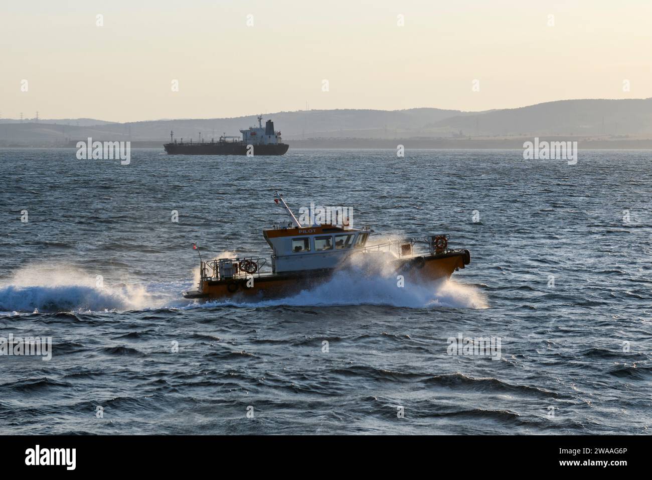 Pilot boat and cargo vessel at sea. Pilot embarkation. Pilotage Stock ...