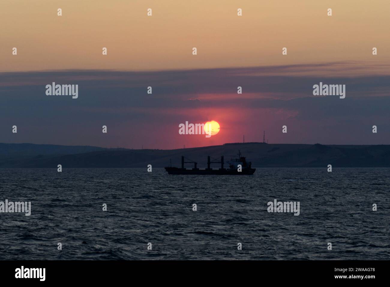 Cargo vessel at sea. Bulk carrier. Dry cargo ship at sunset Stock Photo ...