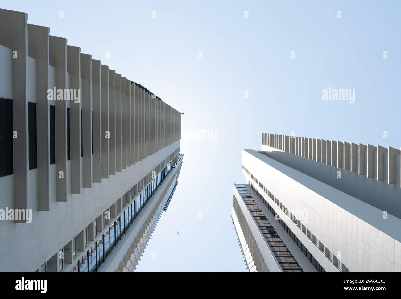 Skyscraper viewed from below with airplane Stock Photo - Alamy