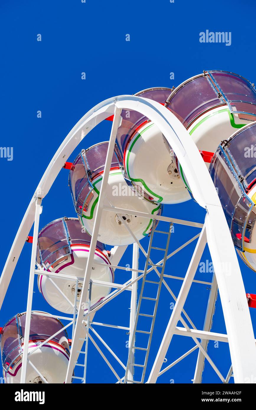 looking up to a close-up, partial image of a modern Ferris wheel in ...