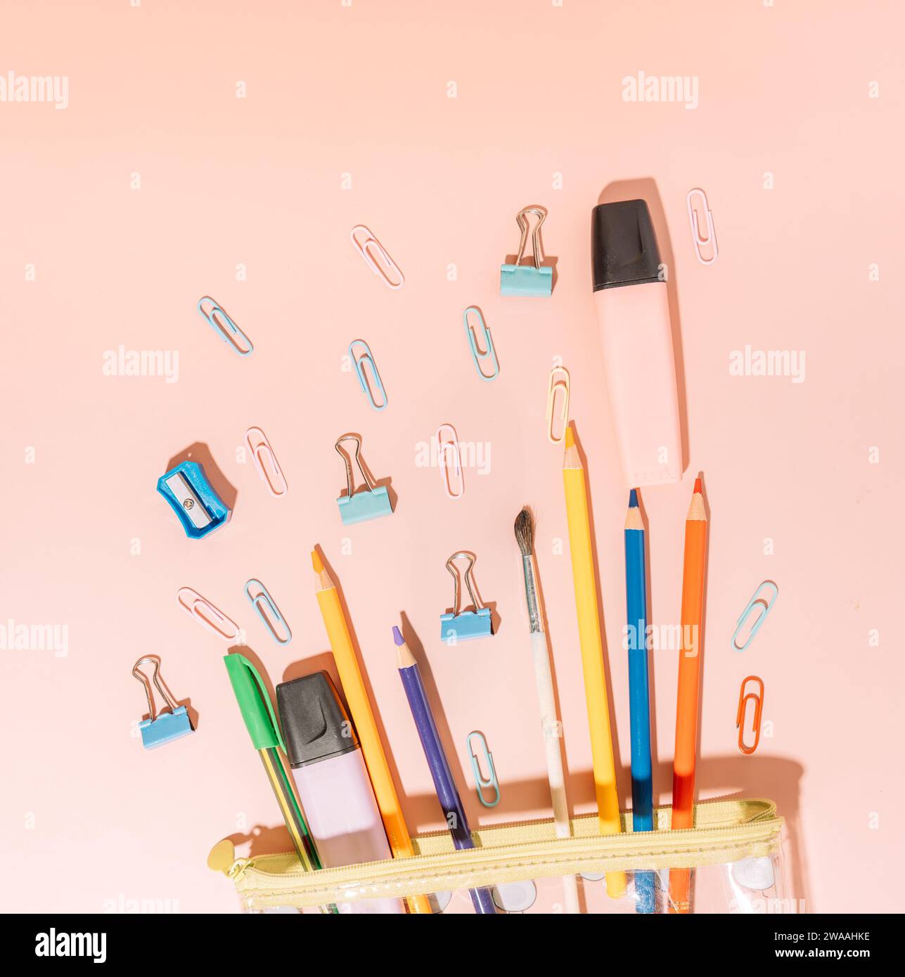 Stationery spills out of a pencil case on a beige background Stock ...