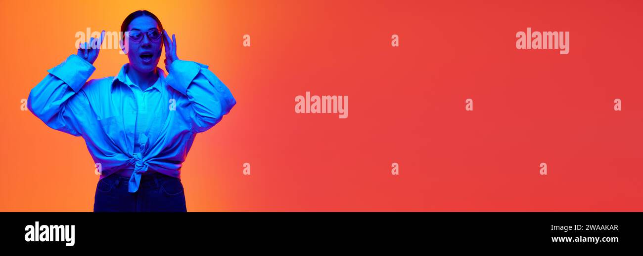 Portrait of attractive, emotive girl, student pointing with finger like ...